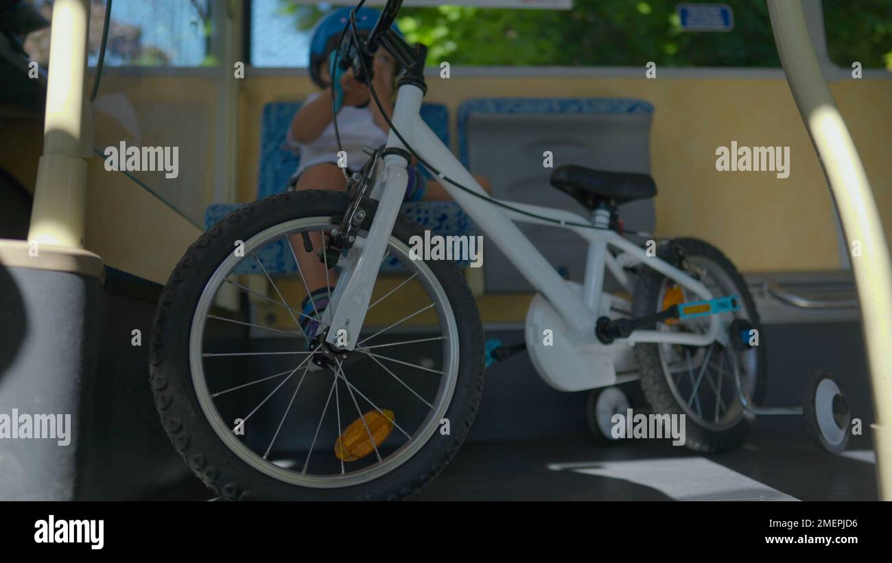 Little boy riding public bus transportation wearing helmet and holding ...