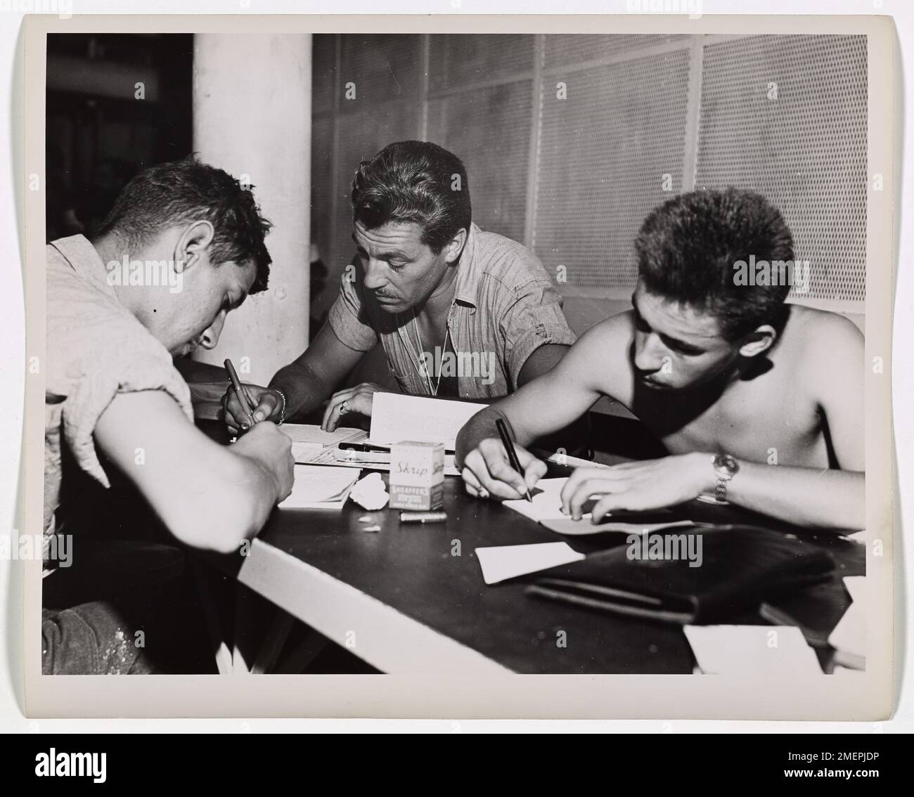 Actor Cesar Romero is seen with fellow U.S. Coast Guardsmen during his ...