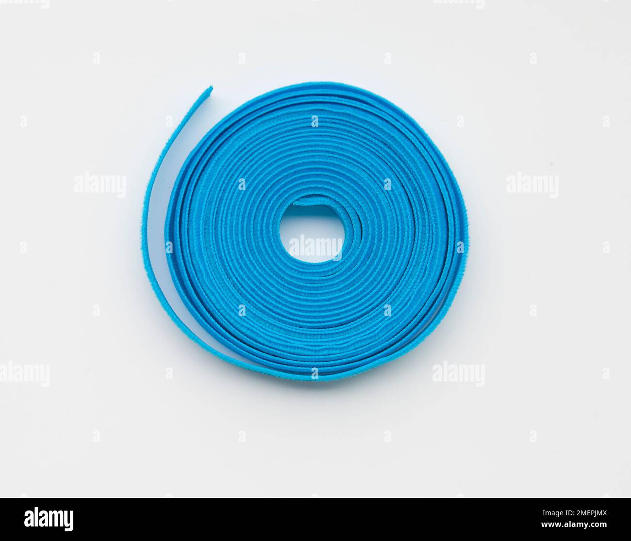 Spiral of blue ribbon trimming Stock Photo - Alamy