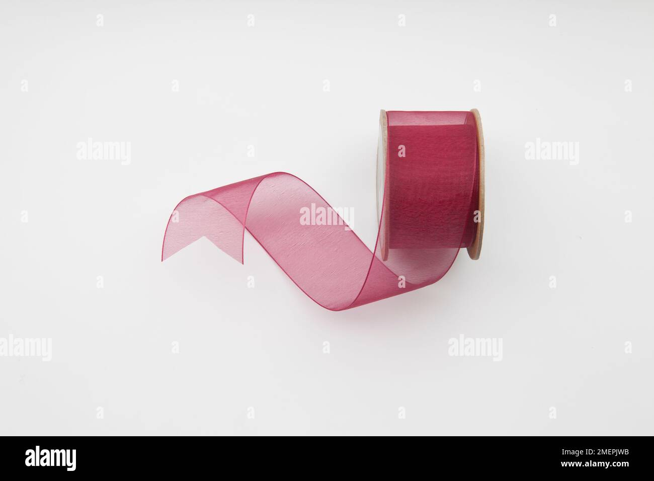 Reel of red ribbon trimming Stock Photo - Alamy