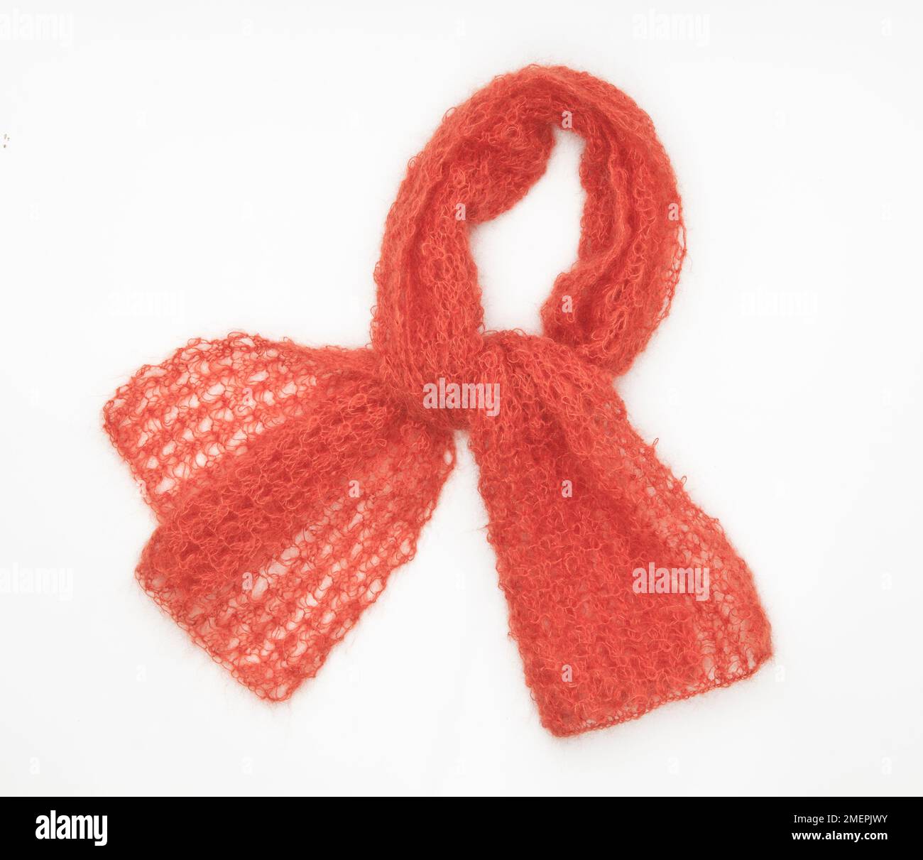 Orange lacy lattice stitch knitted scarf Stock Photo - Alamy