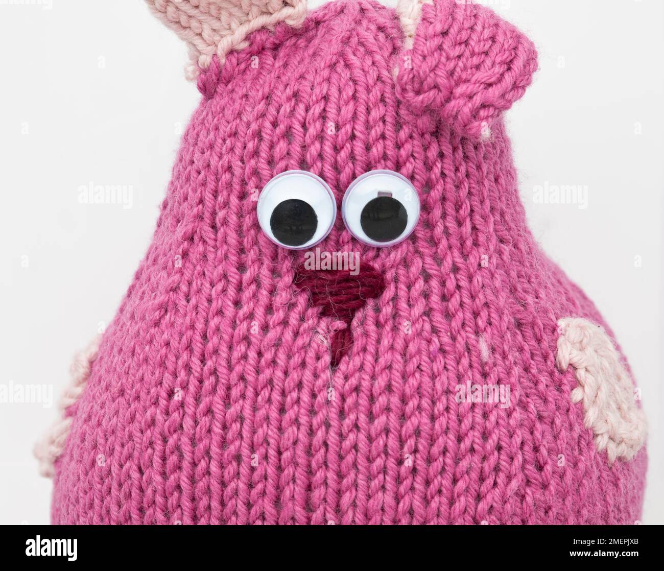 Pink knitted wool cotton toy bunny rabbit toy, close-up Stock Photo - Alamy