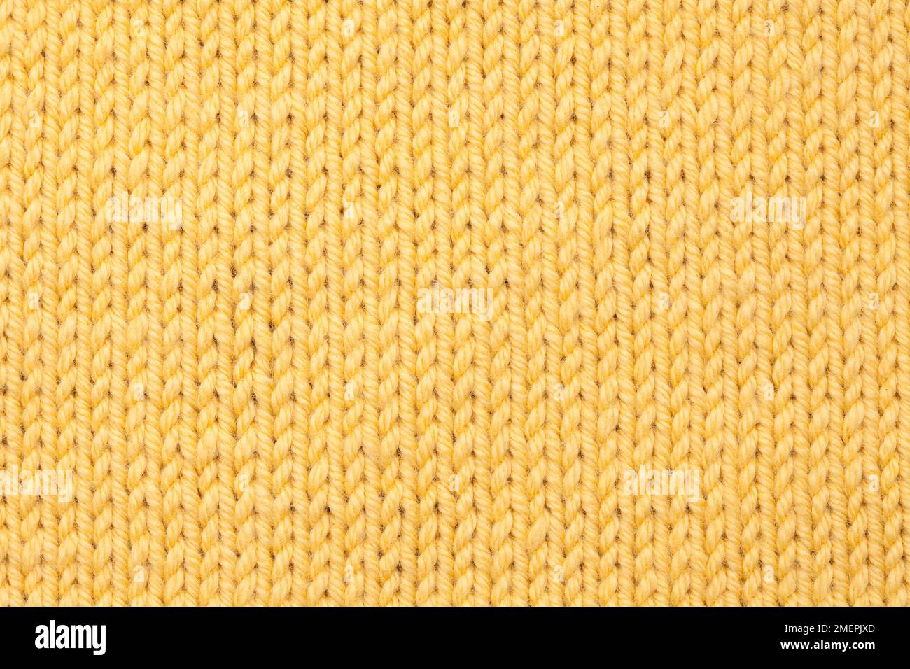 Yellow double stitch knitting wool sample Stock Photo - Alamy