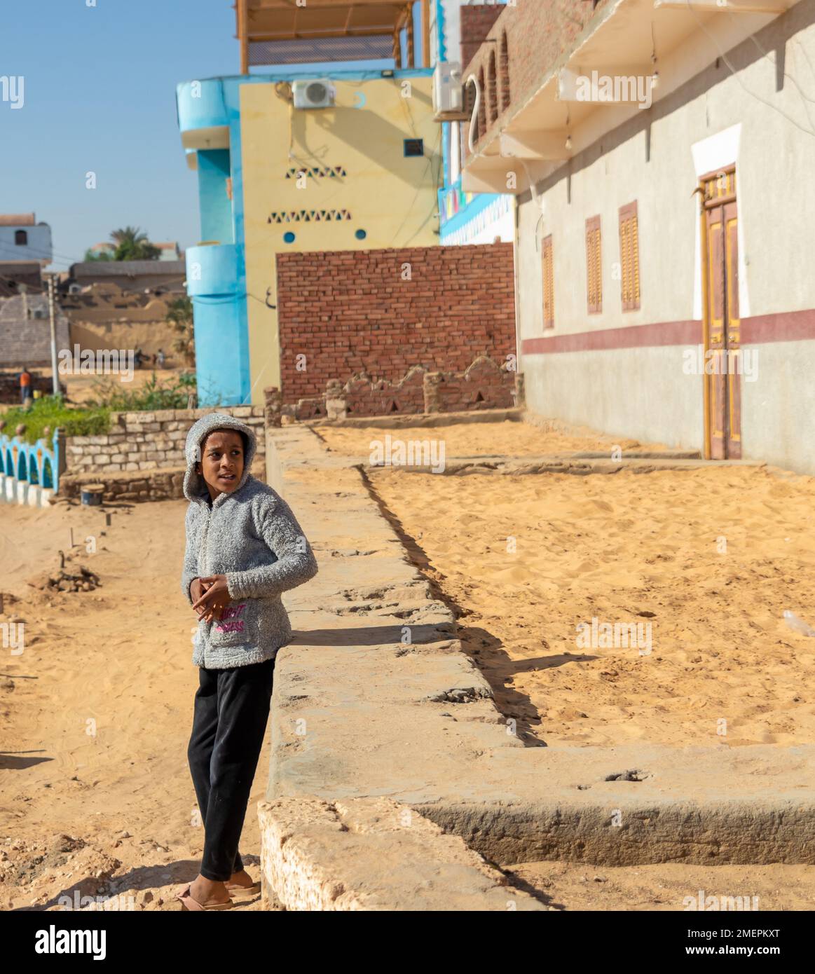 ASWAN, EGYPT - 29 Dec 2022. Poor kid in egyptian colorful village in ...
