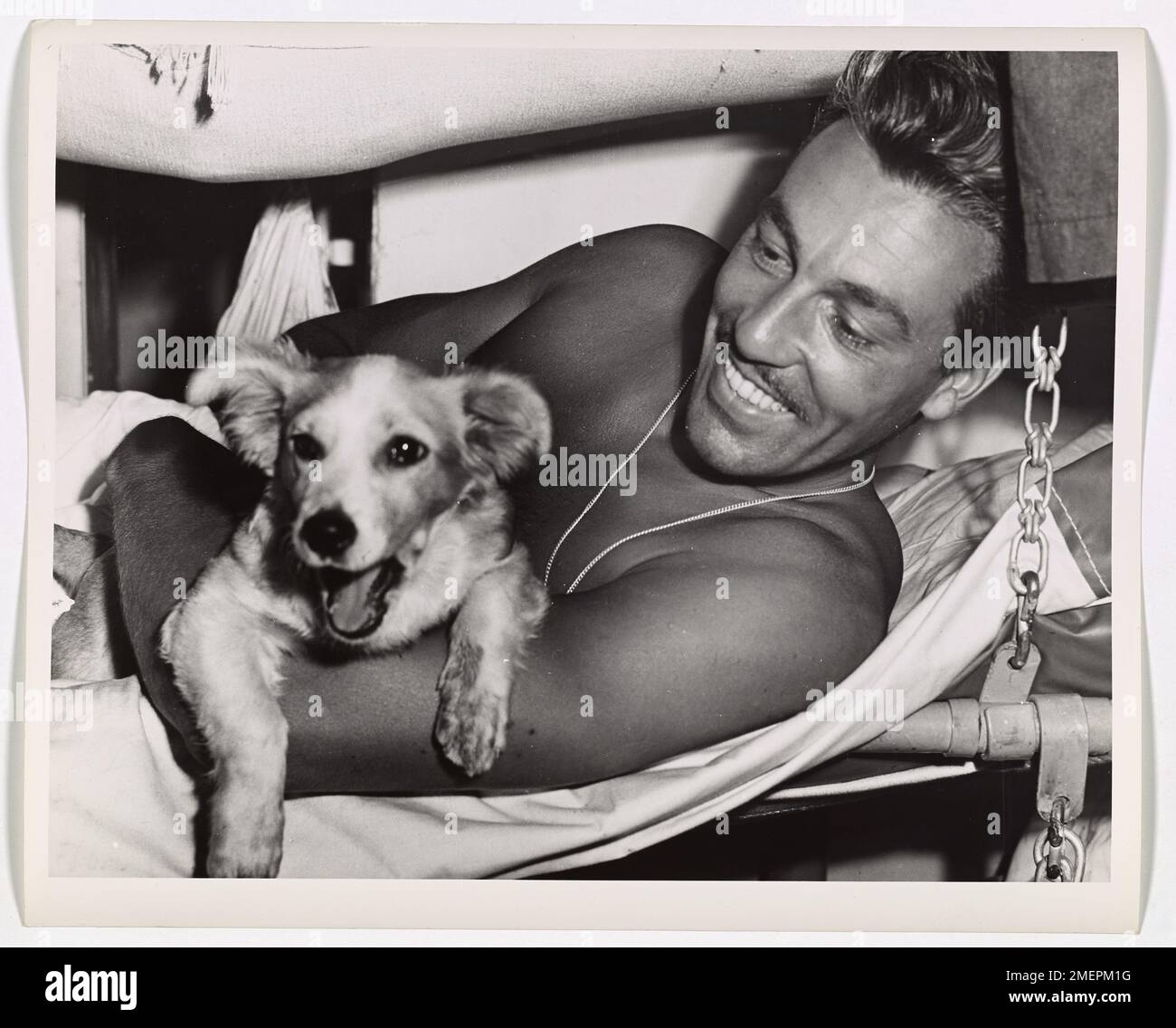 Actor Cesar Romero poses with a dog, demonstrating his connection to ...