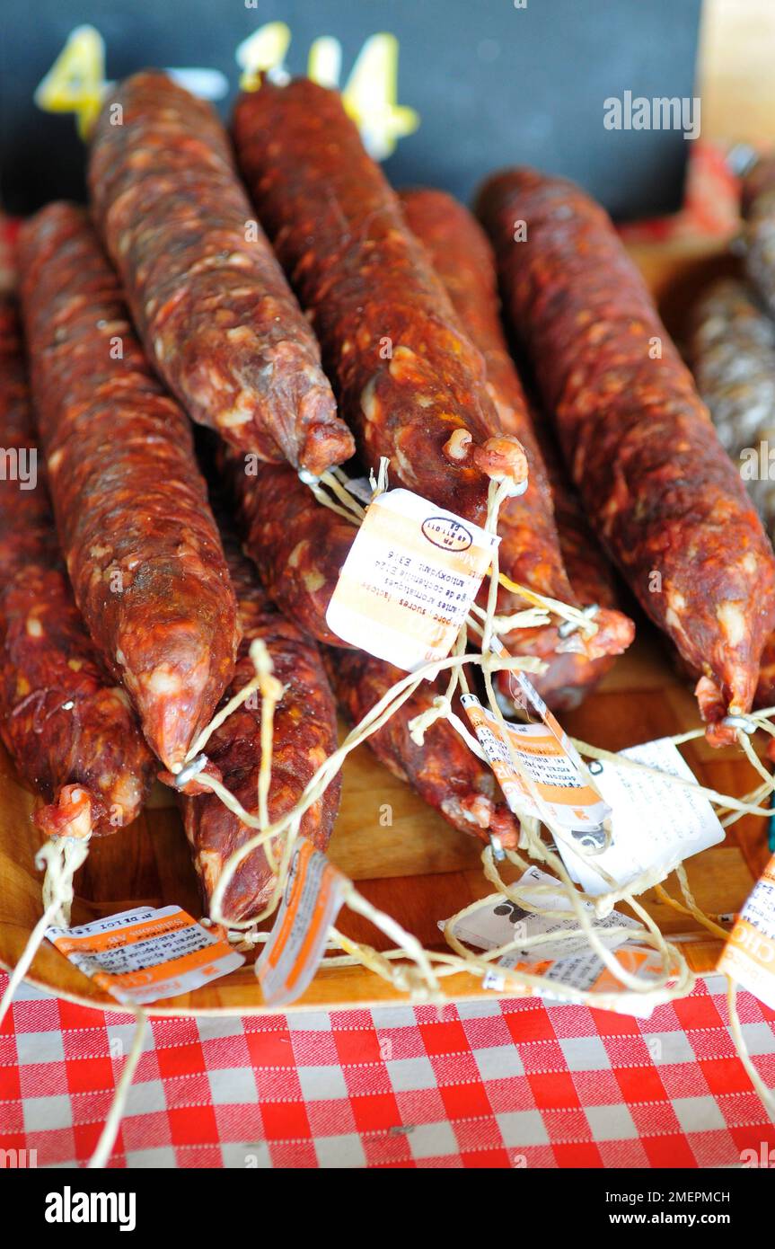 French market stall display of smoked pork saucissons secs Stock Photo ...
