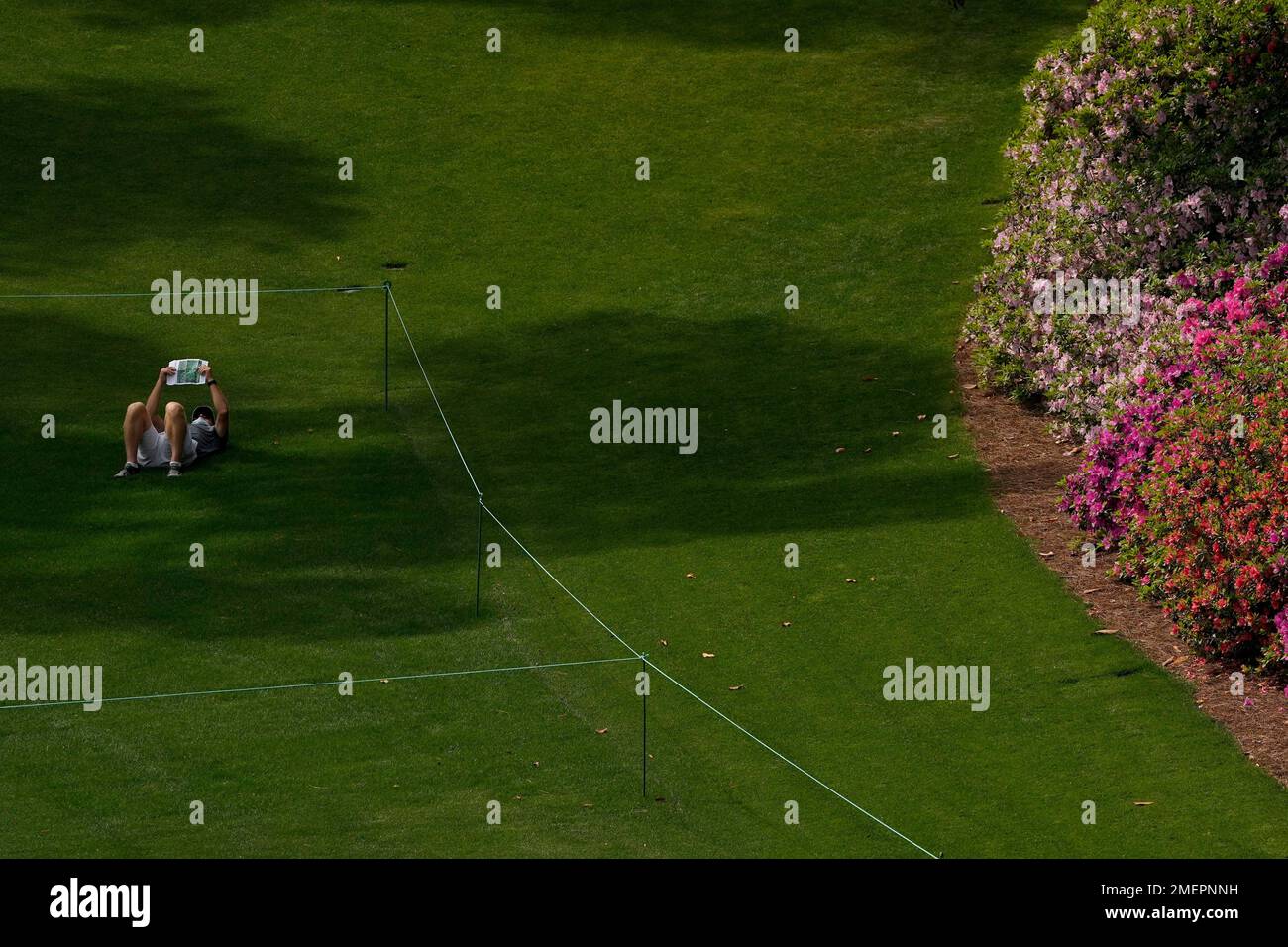 A spectator studies a course map on the sixth hole during the first ...