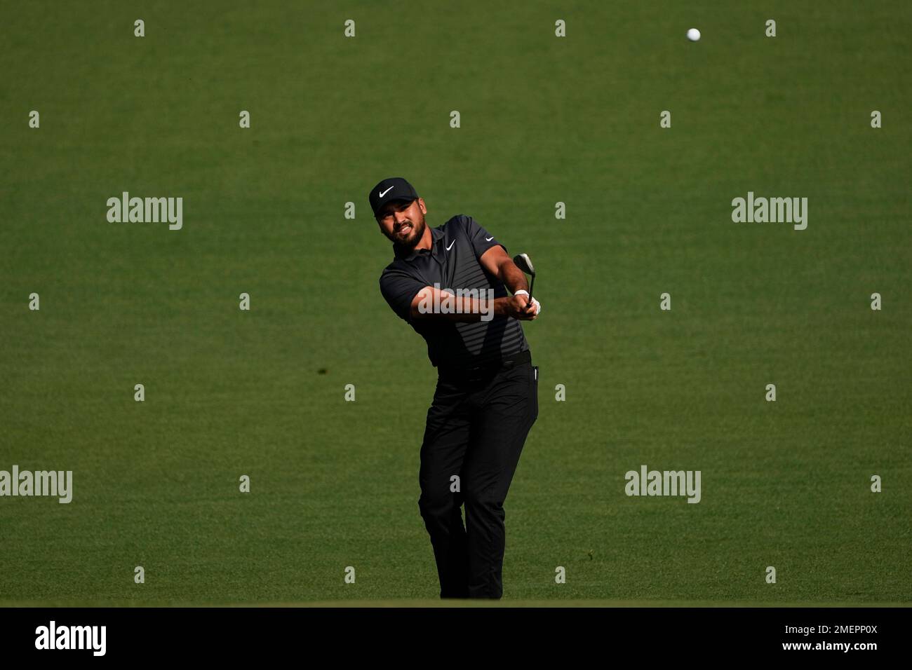 Jason Day, of Australia, chips to the second green during the first ...