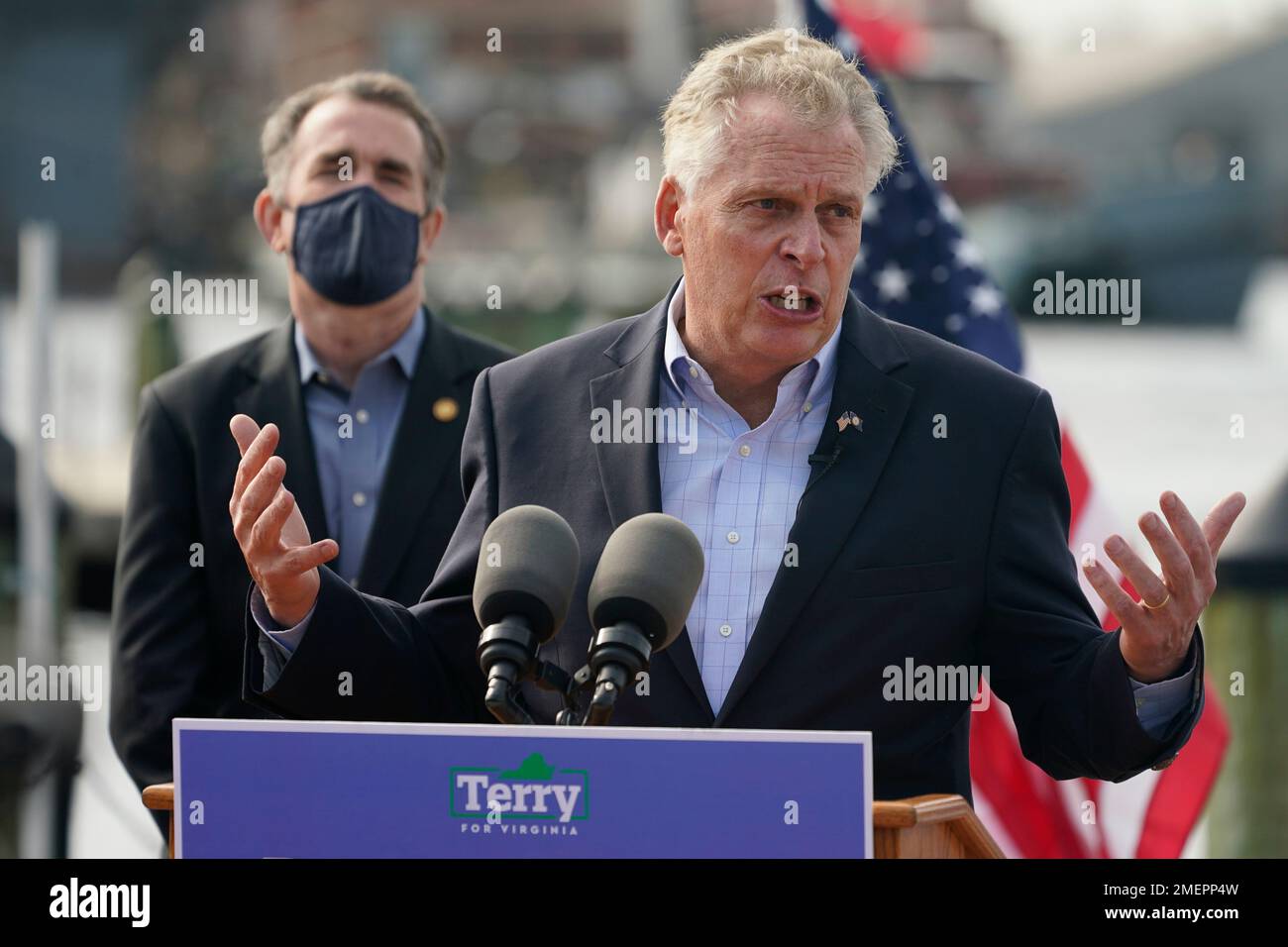 Former Virginia Gov. Terry McAuliffe, right, gestures during a news ...