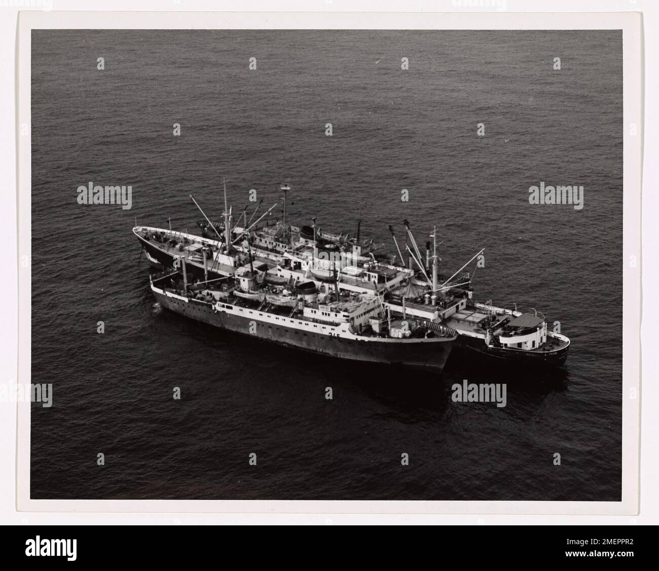 This image shows a Soviet stern trawler anchored alongside a supply ...