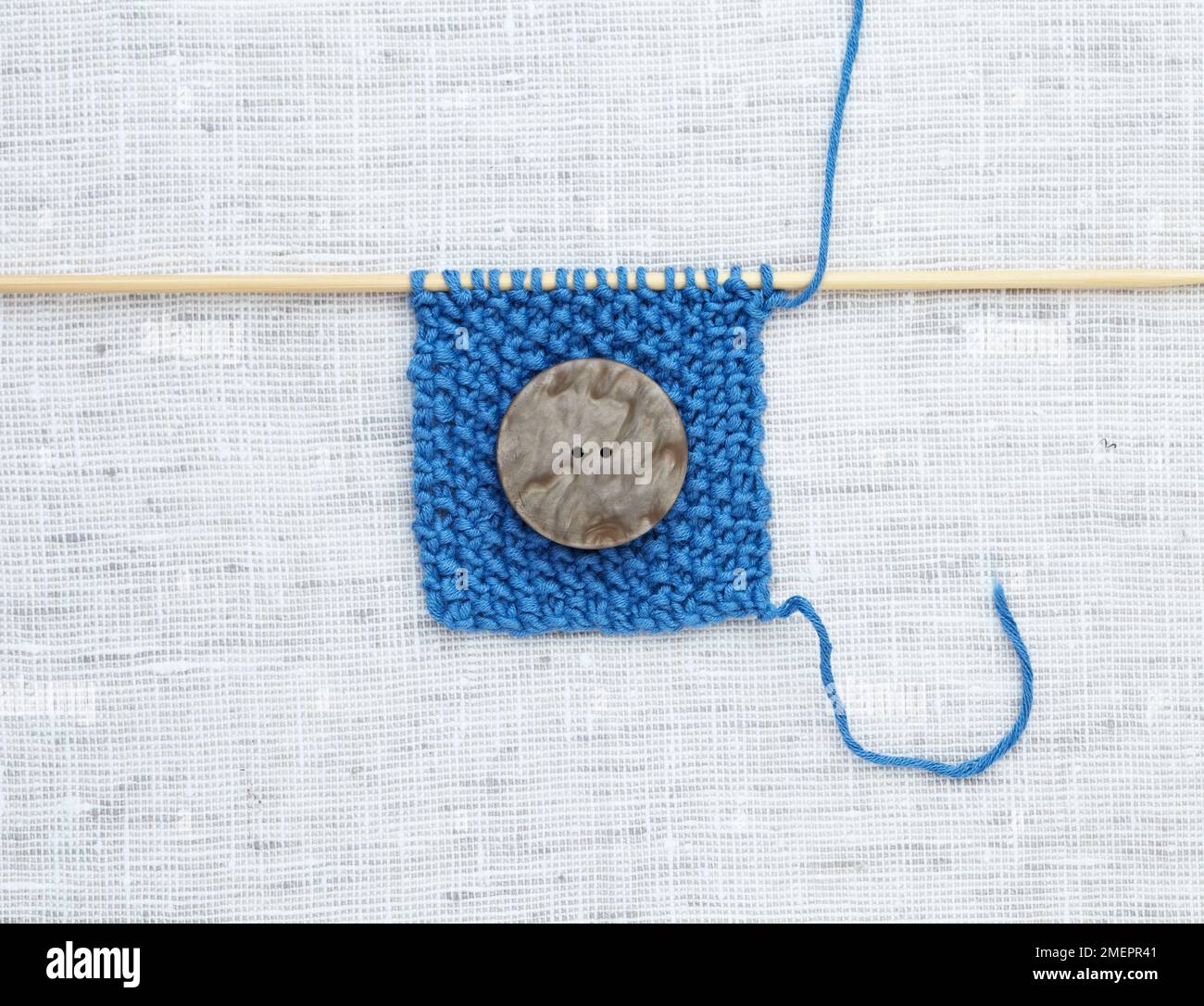 Button on a piece of blue knitting (making covered buttons Stock Photo ...