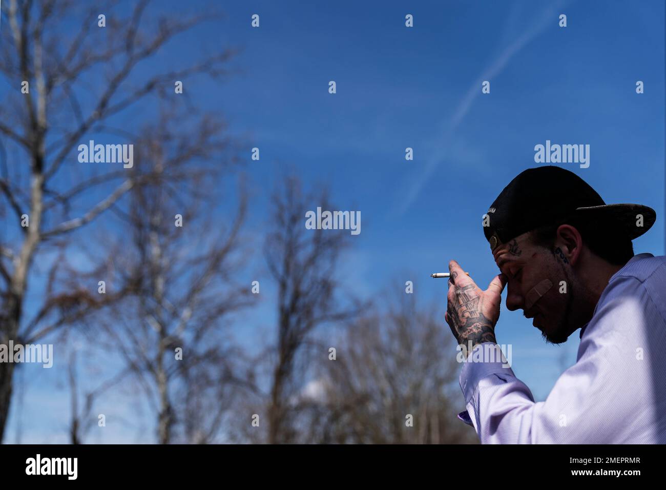 Joshua Messer, 29, sits on the front stoop of his aunt's house where he ...