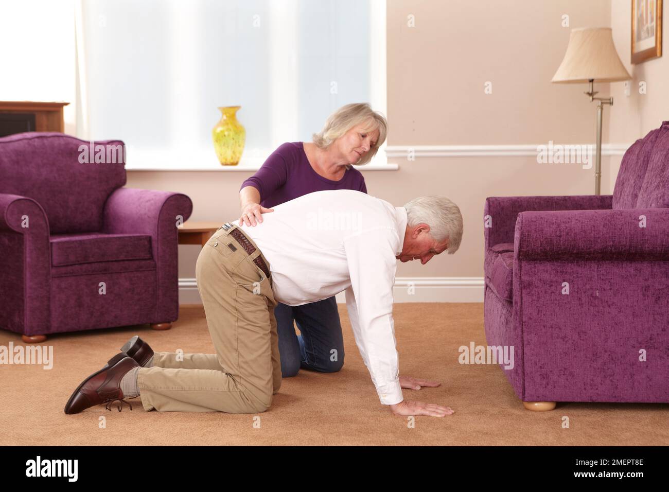 Helping person to the crawling position after fall Stock Photo - Alamy