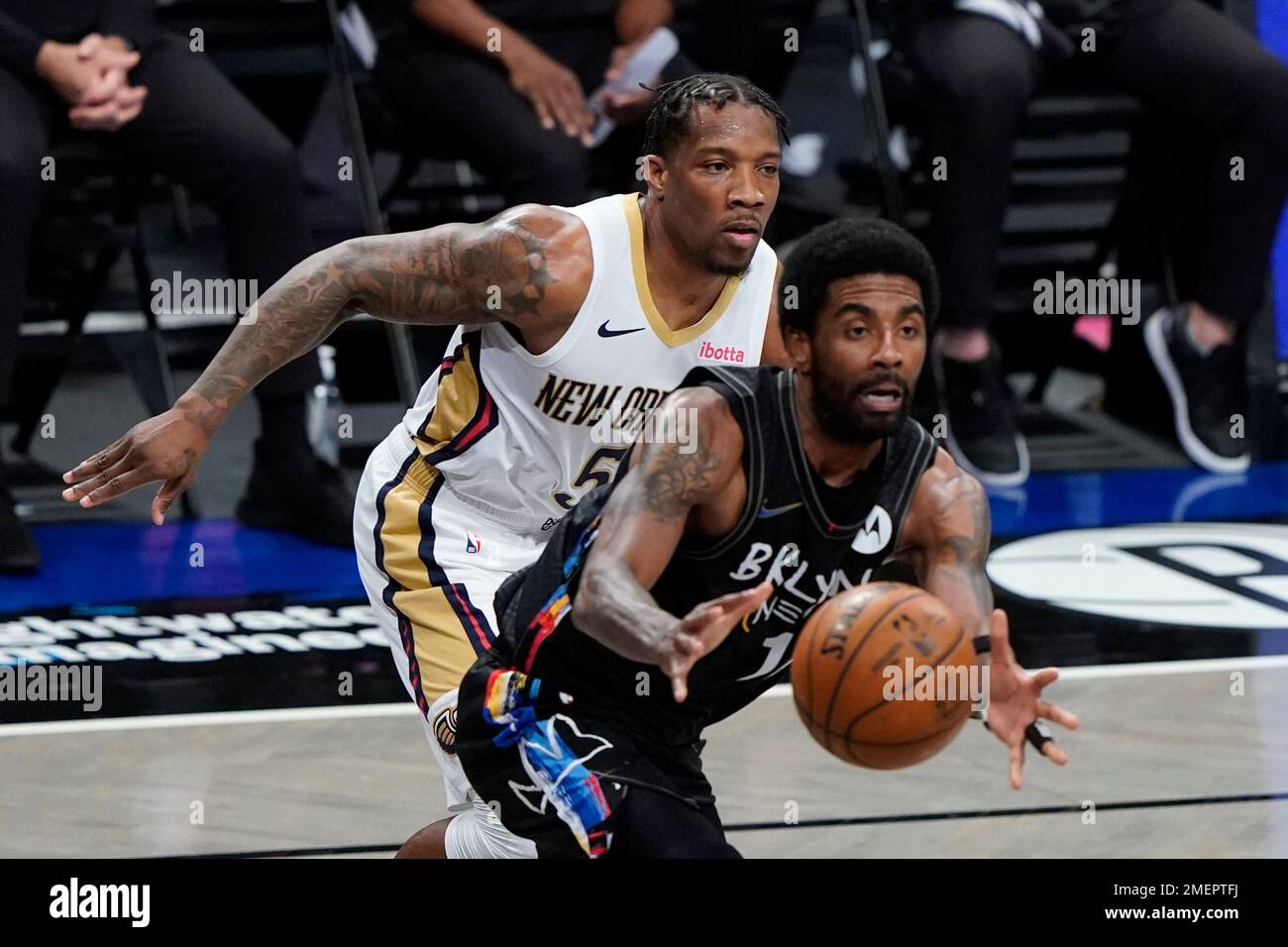 Brooklyn Nets' Kyrie Irving (11) drives past New Orleans Pelicans' Eric ...
