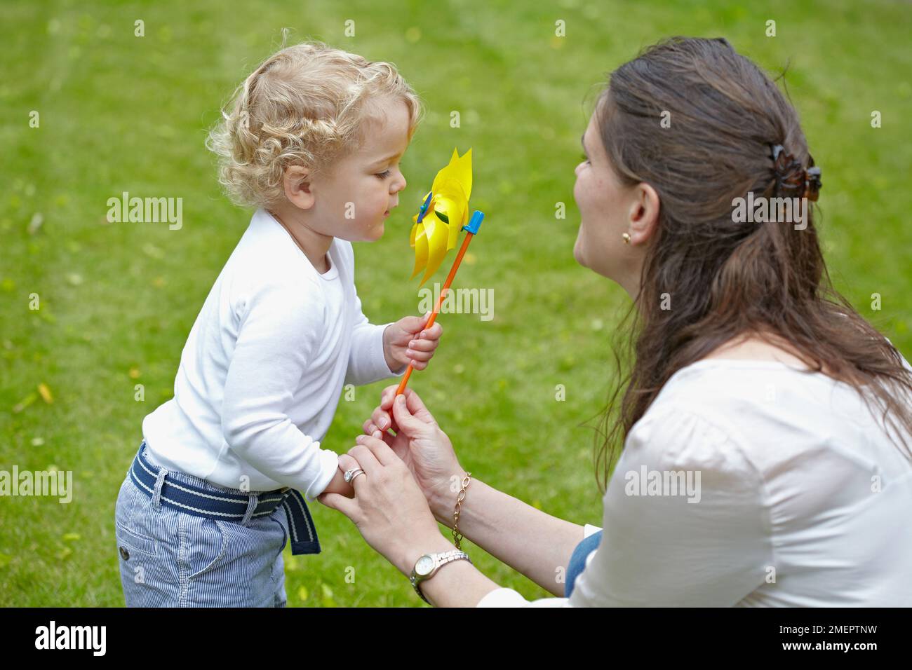 Woman holding boy blowing windmill, 2 years 4 months Stock Photo - Alamy Woman holding boy blowing windmill, 2 years 4 months Stock Photo - Alamy