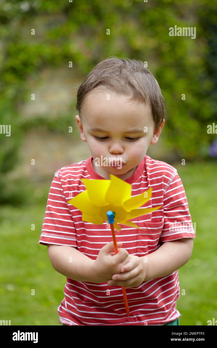 Child with windmill hi-res stock photography and images - Alamy