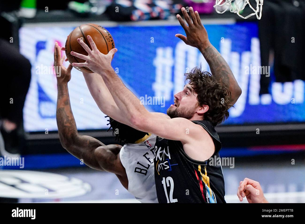 Brooklyn Nets' Joe Harris (12) fights for control of the ball with New ...