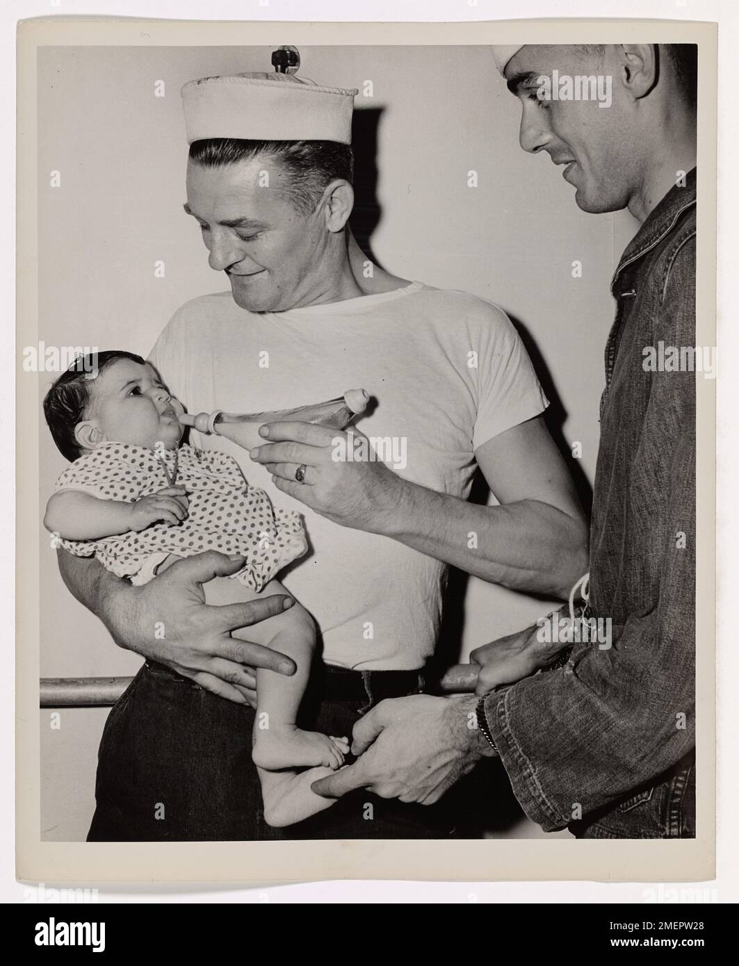 Two Coast Guardsmen care for a refugee baby aboard a Coast Guard ...