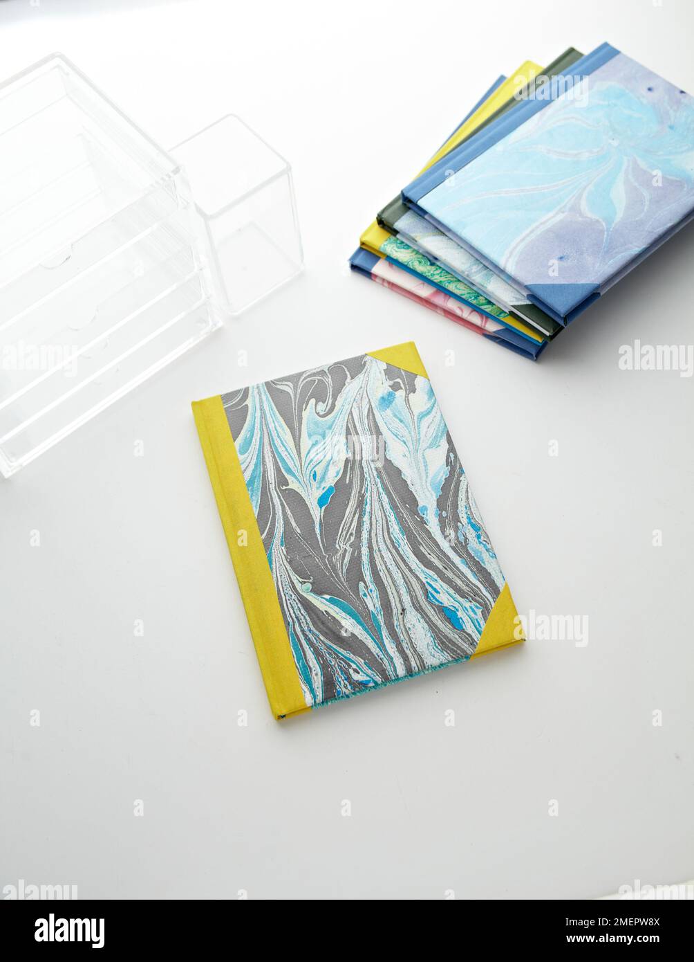 Marbled book cover with yellow corners, close-up Stock Photo - Alamy