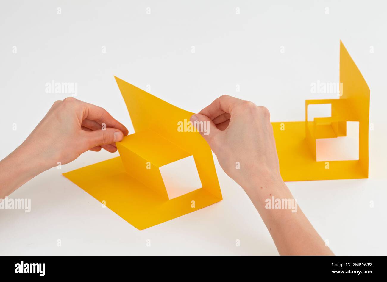 Folding across scored lines to make pop-up greetings card, close-up ...