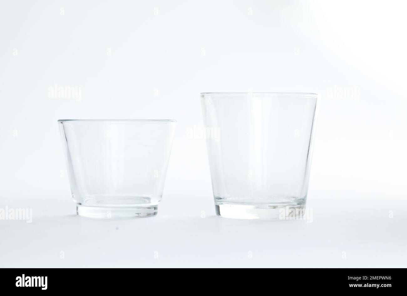 Two plain drinking glasses, close-up Stock Photo - Alamy