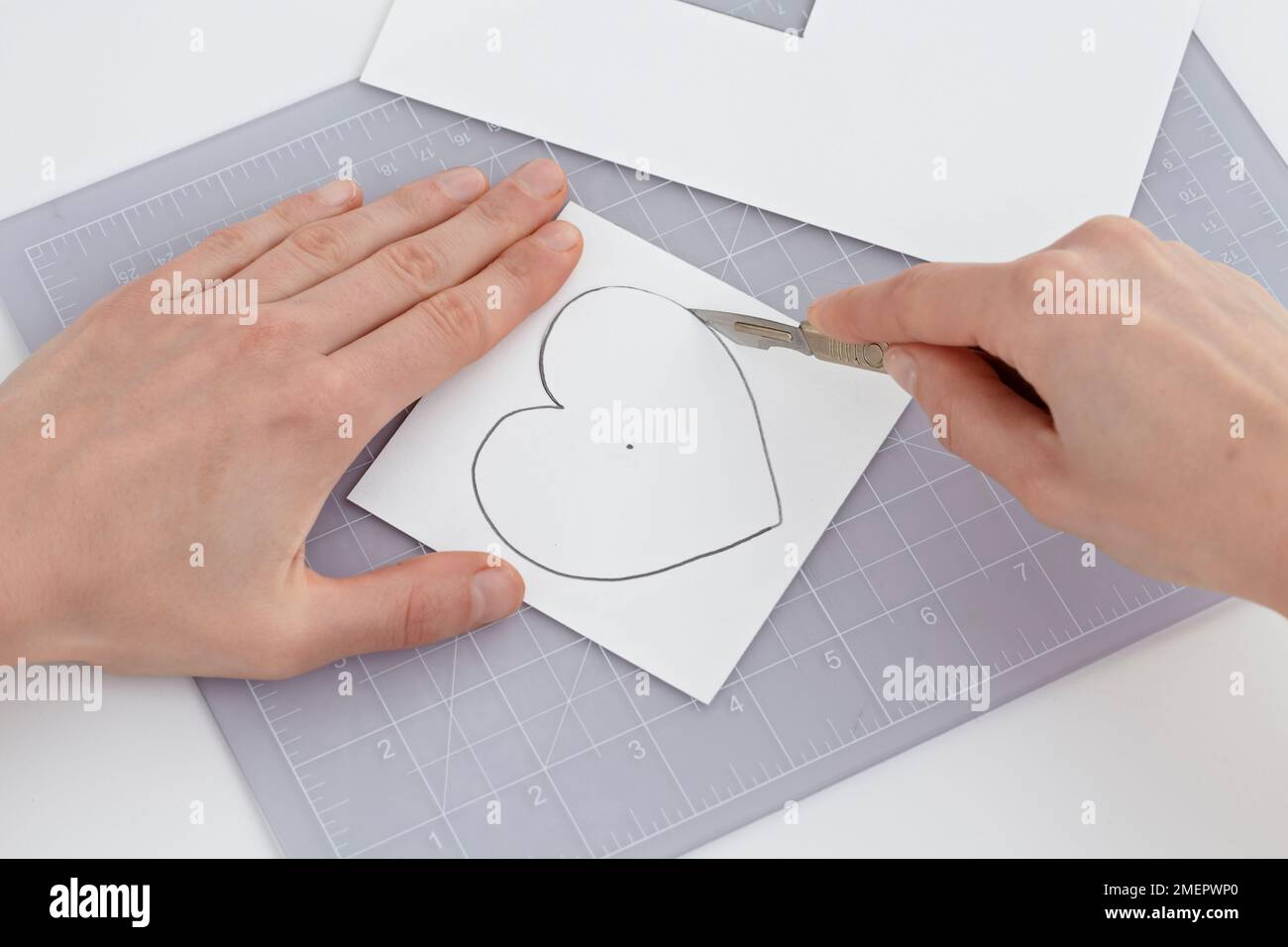 Cutting paper heart hi-res stock photography and images - Alamy