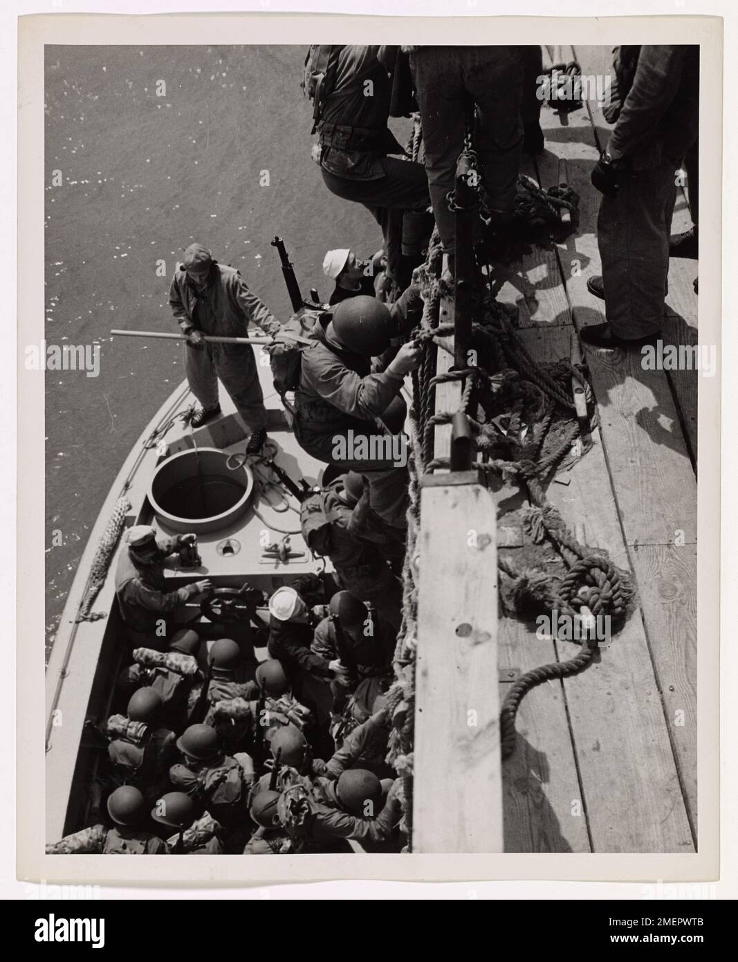 This image shows soldiers boarding a Coast Guard landing craft during ...