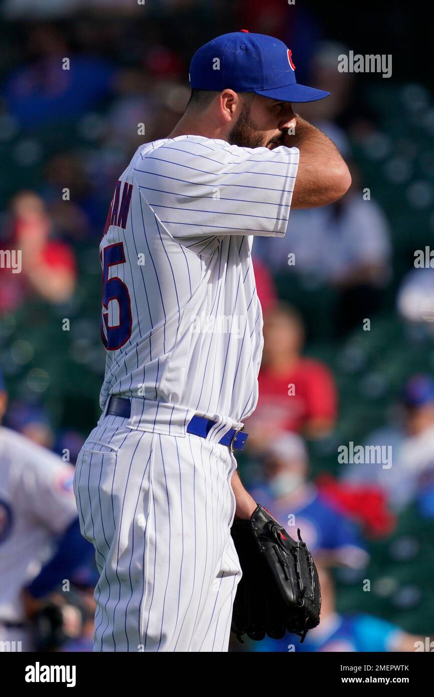 Chicago Cubs relief pitcher Brandon Workman wipes his face during the ...