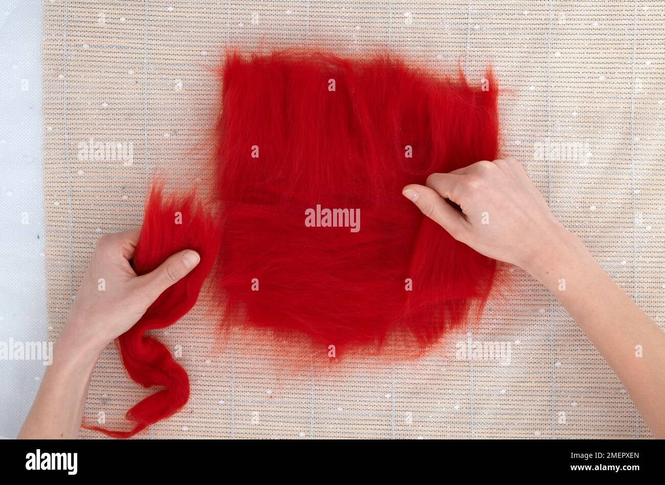 Lay third layer of carded fleece at right angles to the second layer ...