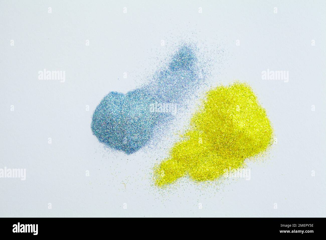 Heaps of blue and yellow glitter, overhead view Stock Photo - Alamy
