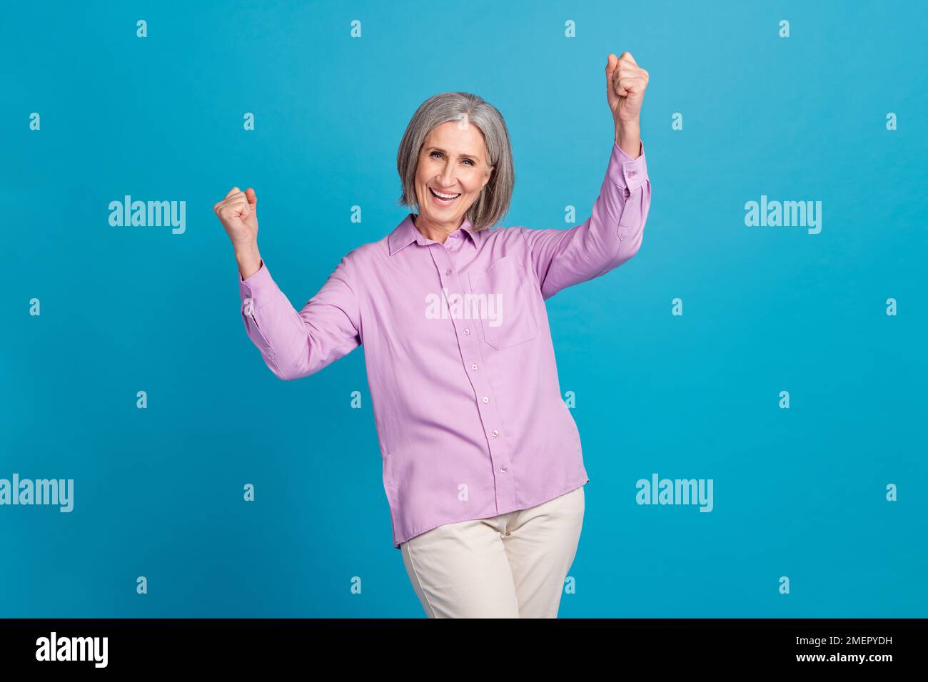 Photo of cheerful lady wear trendy clothes raise hands fist celebrate ...