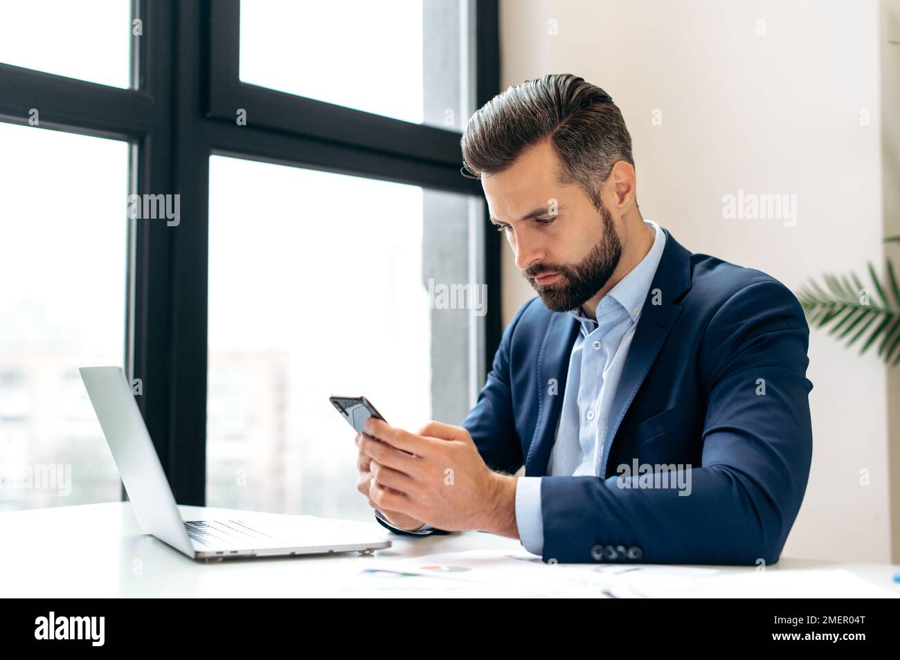 Focused serious caucasian business man, manager, director, sits at a ...
