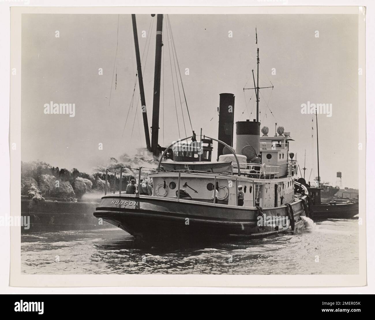 This image shows several boats fighting a large fire, likely in the ...