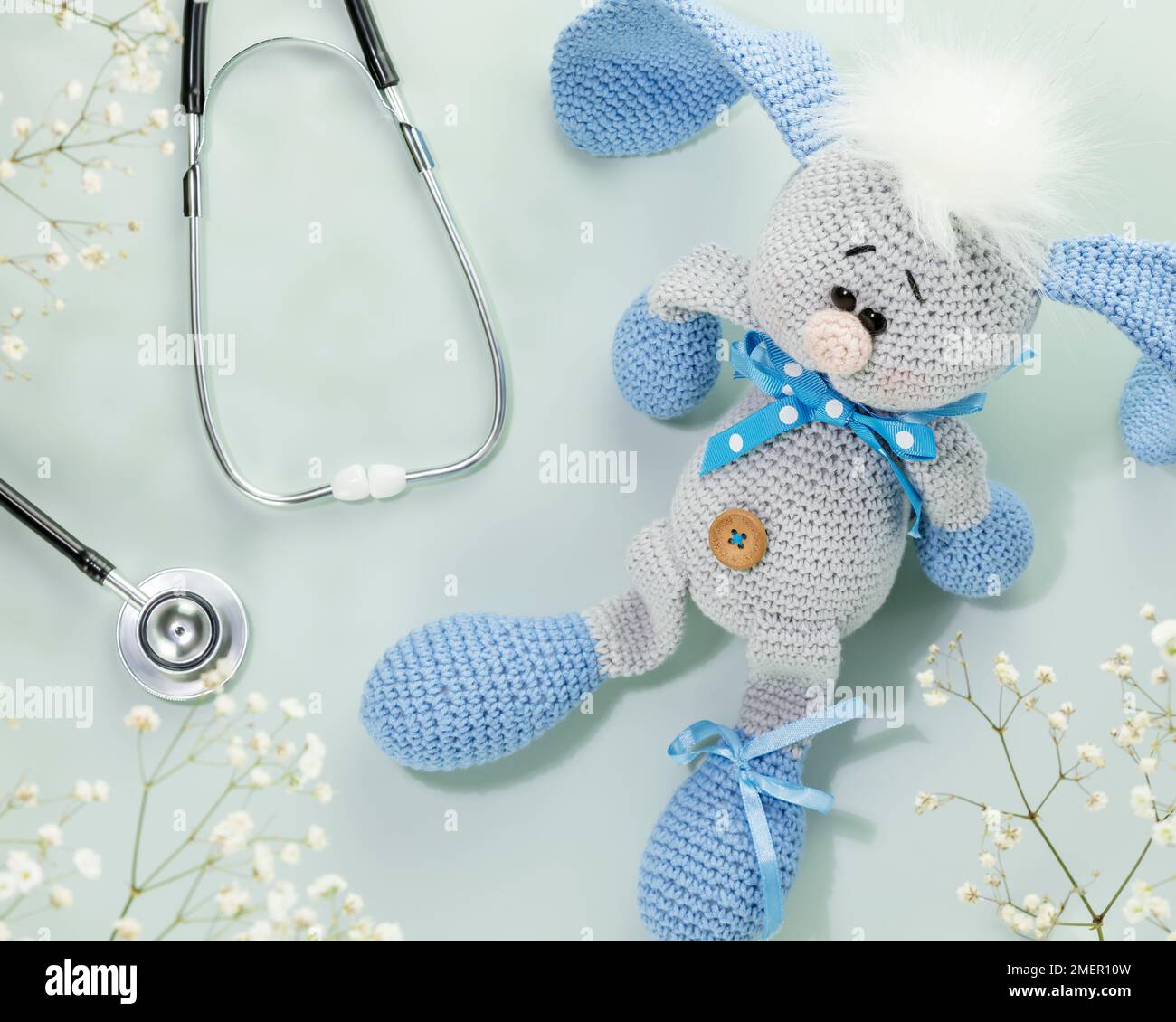 Kids health care card. Cute knitted toy rabbit with a stethoscope on ...