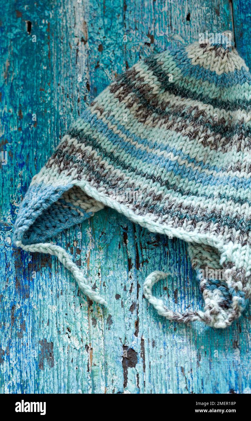 Stripy chullo earflap hat on blue wood background Stock Photo - Alamy