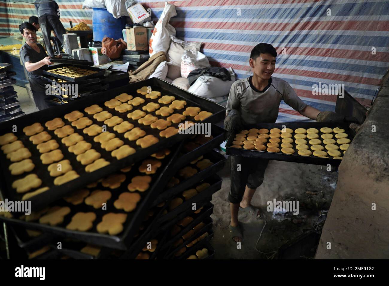 Afghan bakers prepare sweets at a traditional bakery ahead of the ...