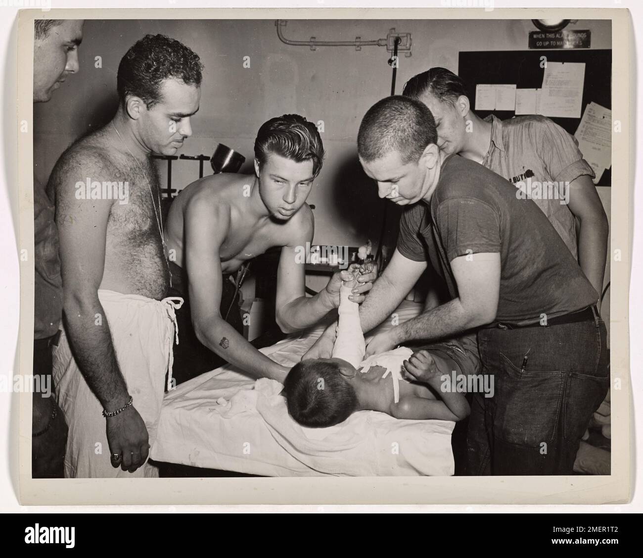A wounded Japanese child from the Battle of Saipan receives medical ...