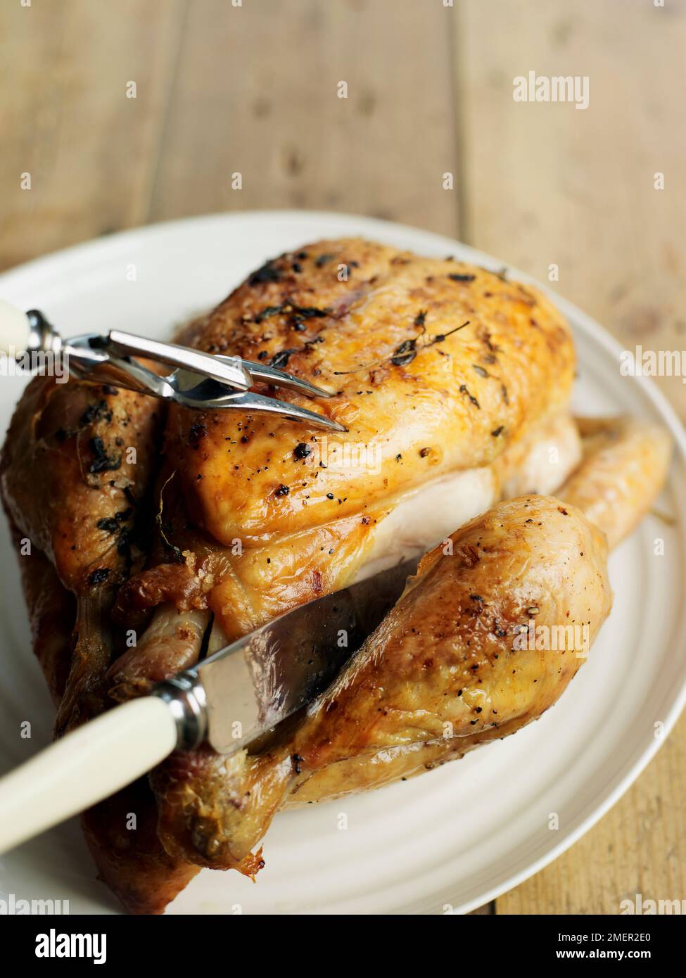 Removing cooked roast chicken hi-res stock photography and images - Alamy