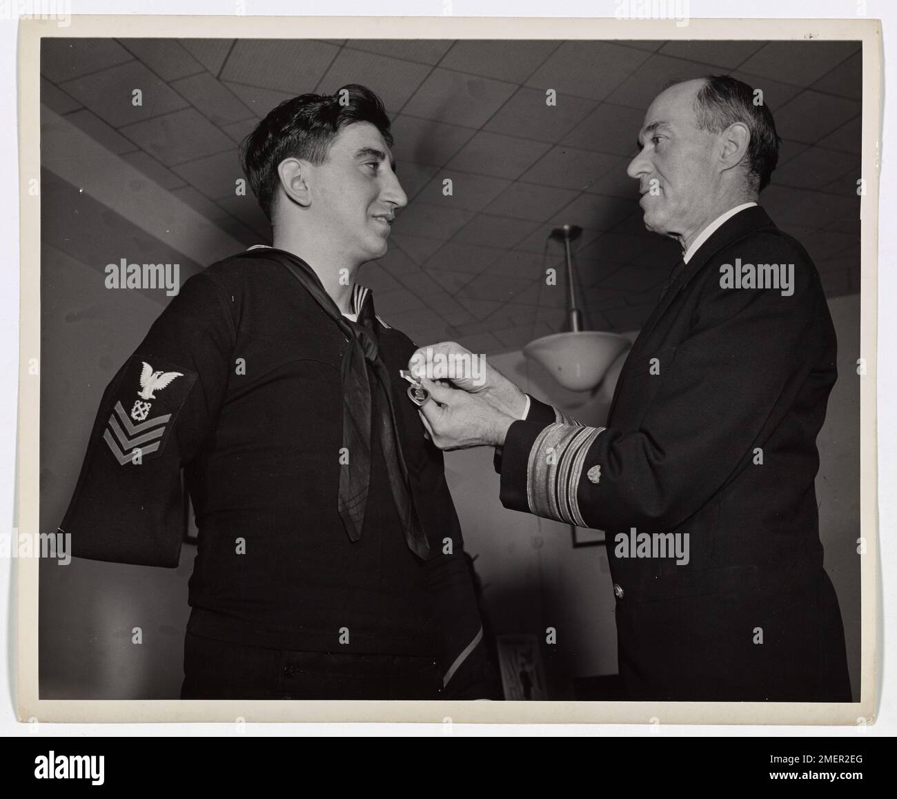 Coast Guardsman Thomas Sortino of Forest Park, Illinois, receives the ...