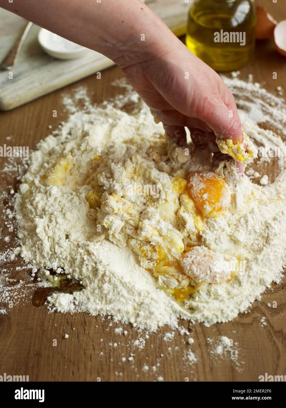Mixing egg, olive oil and flour (making pasta dough Stock Photo - Alamy