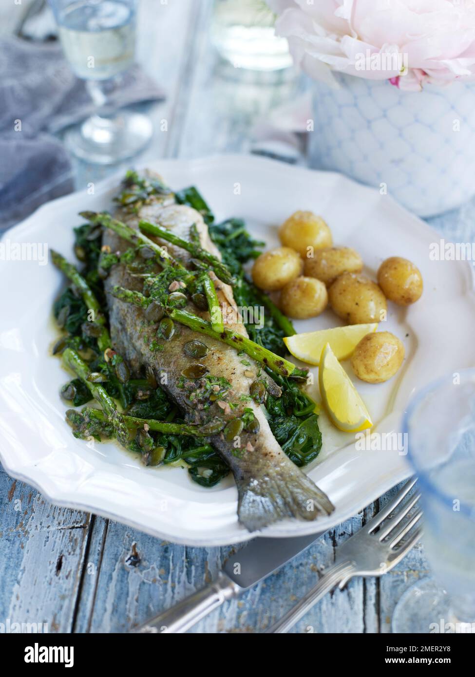 Sauted trout on wilted spinach with boiled baby potatoes Stock Photo ...