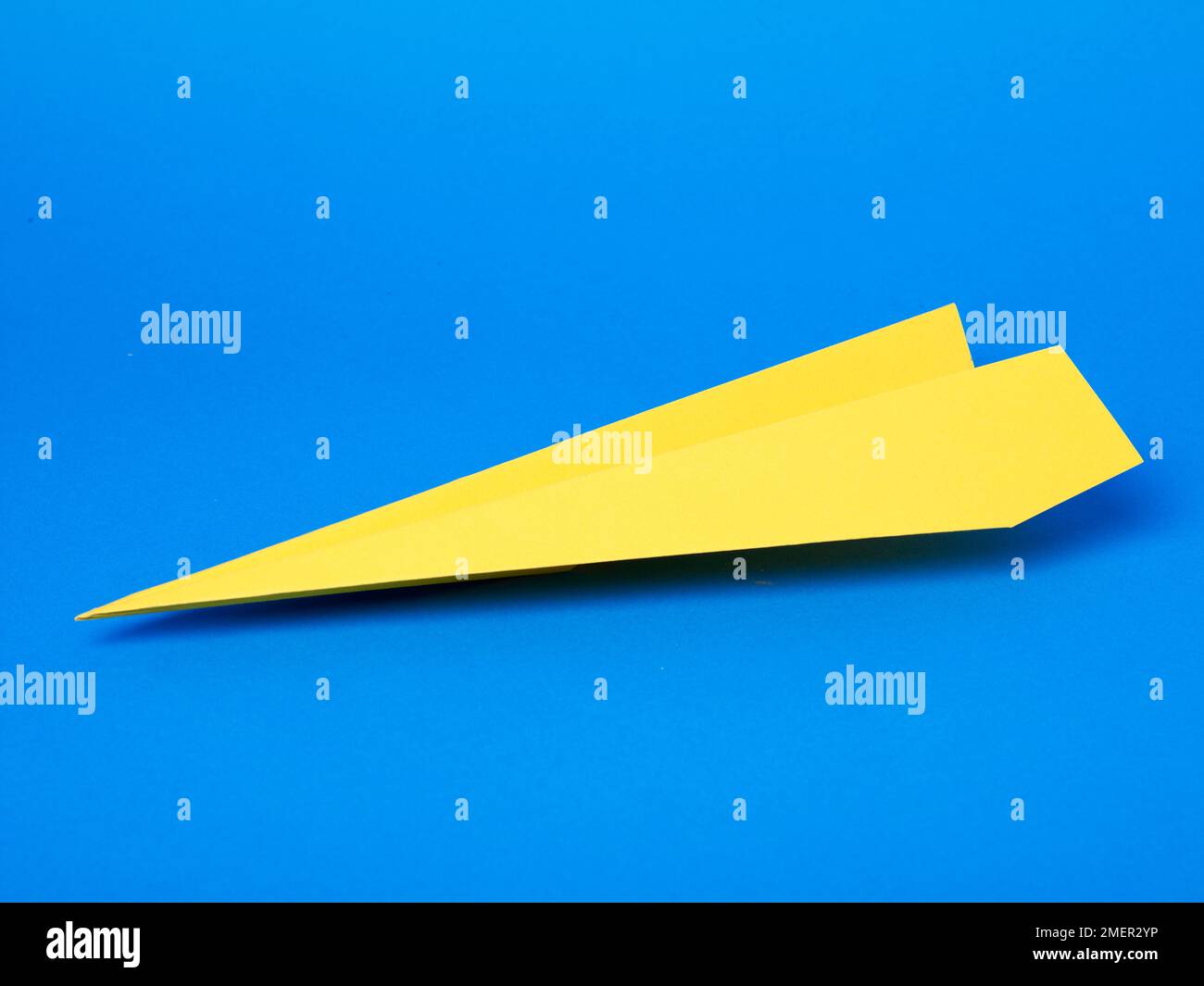 Yellow paper plane Stock Photo - Alamy