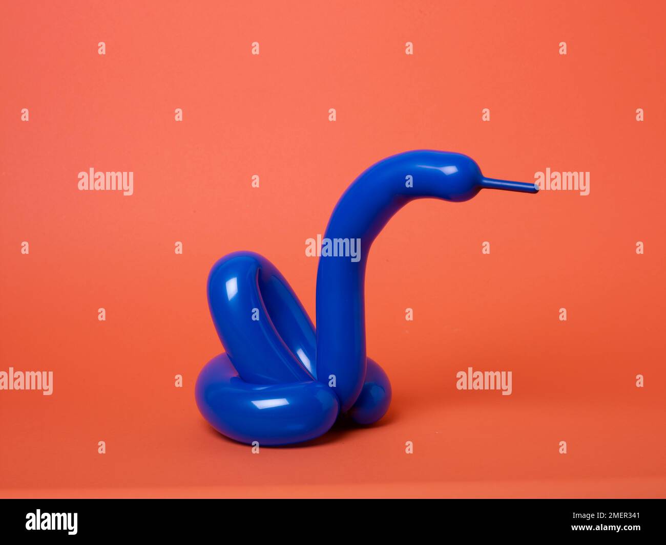Blue balloon swan on red background Stock Photo - Alamy