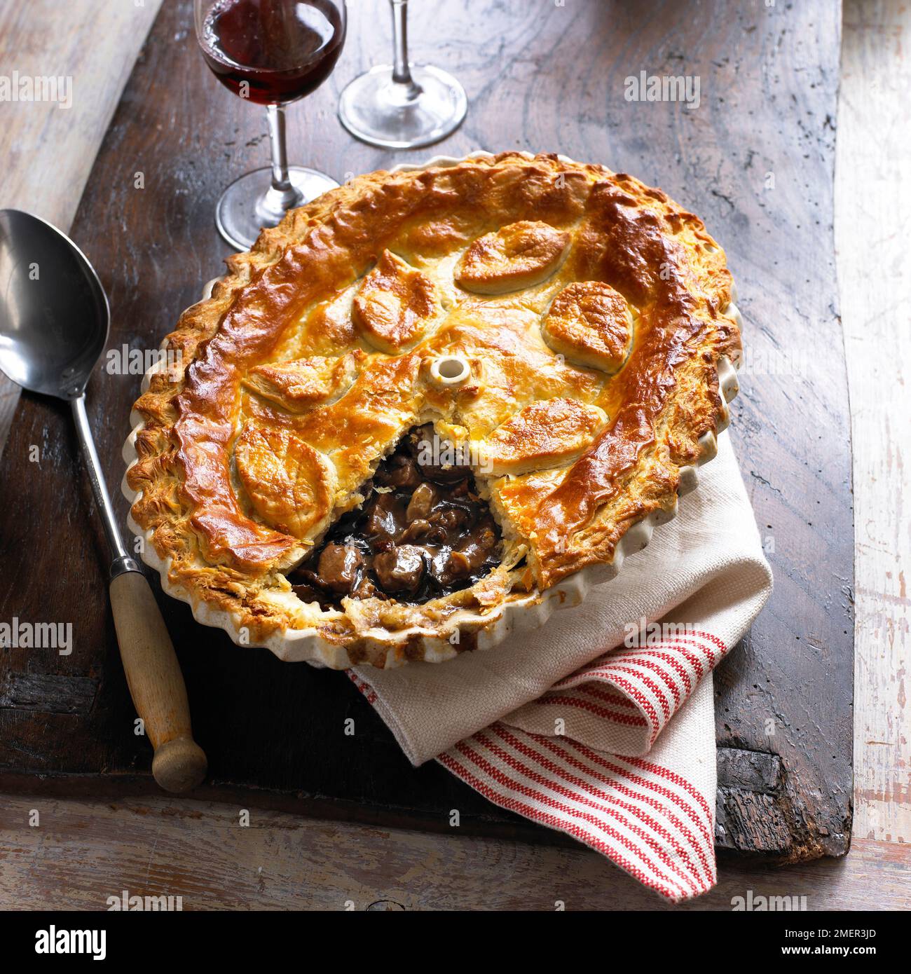 Baked crust of steak and wild mushroom pie, with part of crust missing ...