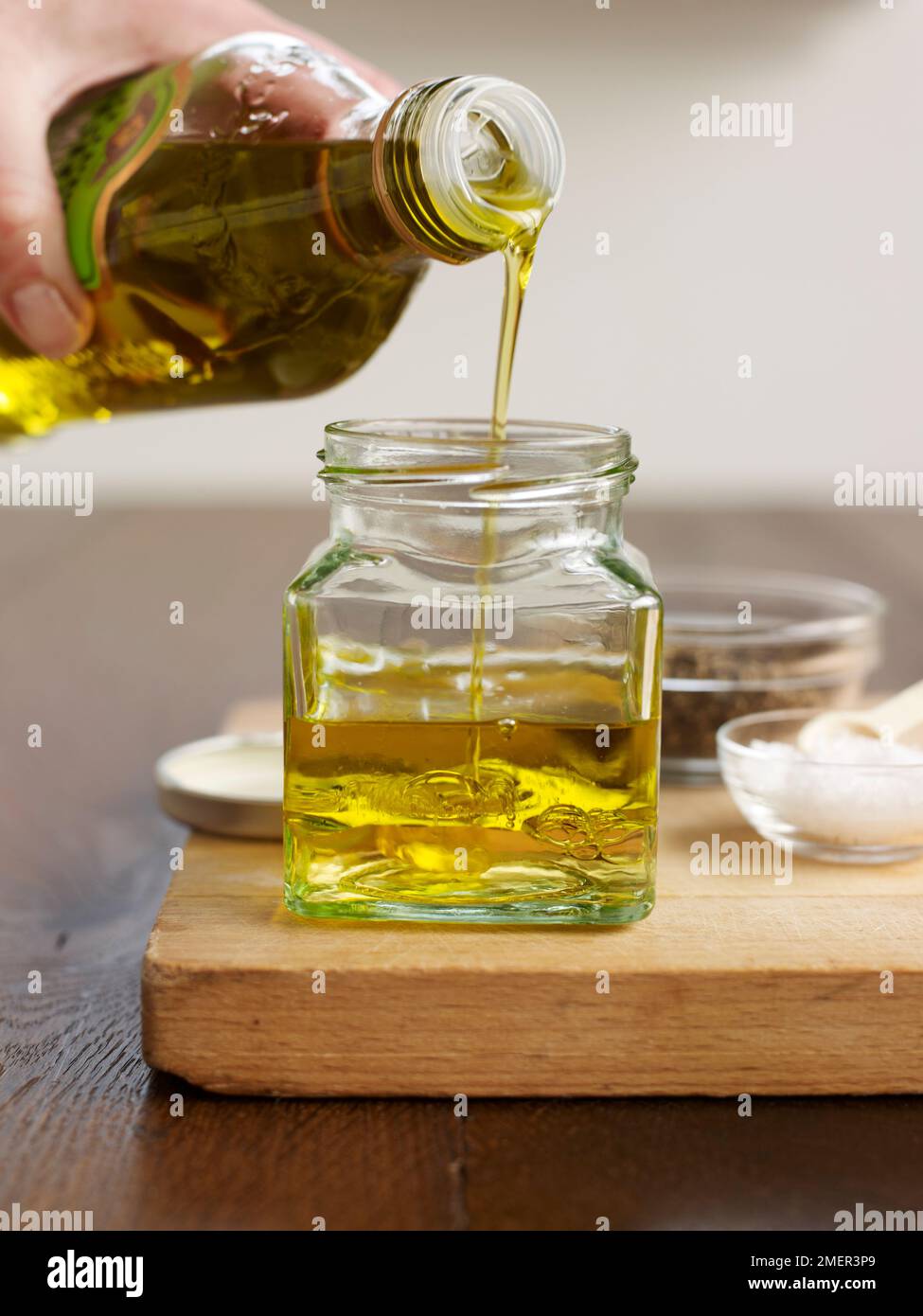 Human hand pouring oil in hi-res stock photography and images - Alamy