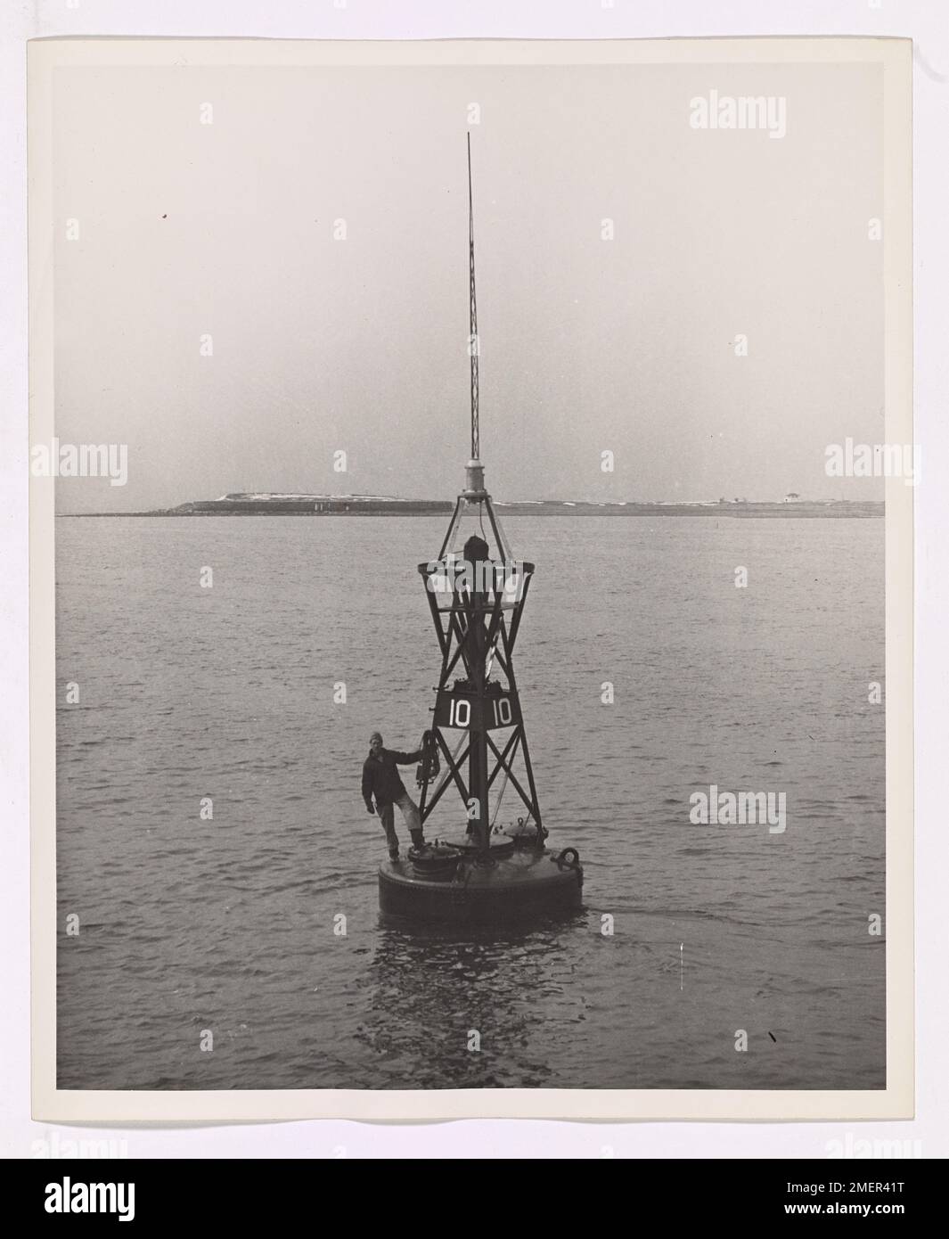 This photograph shows an individual standing on top of a numbered radio ...