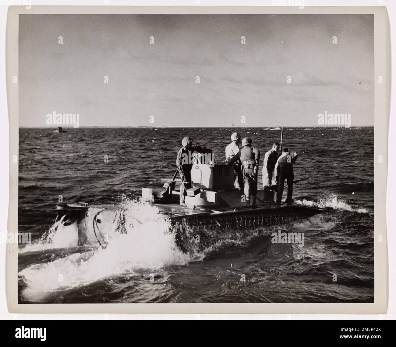 An amphibious tank moves through the foamy waters of Kwajalein Lagoon ...