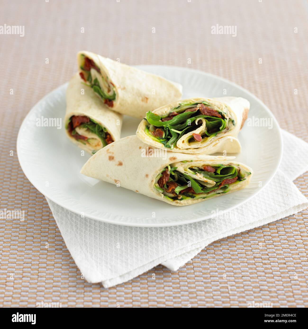 Griddled courgette, semi-dried tomato and rocket wraps Stock Photo - Alamy