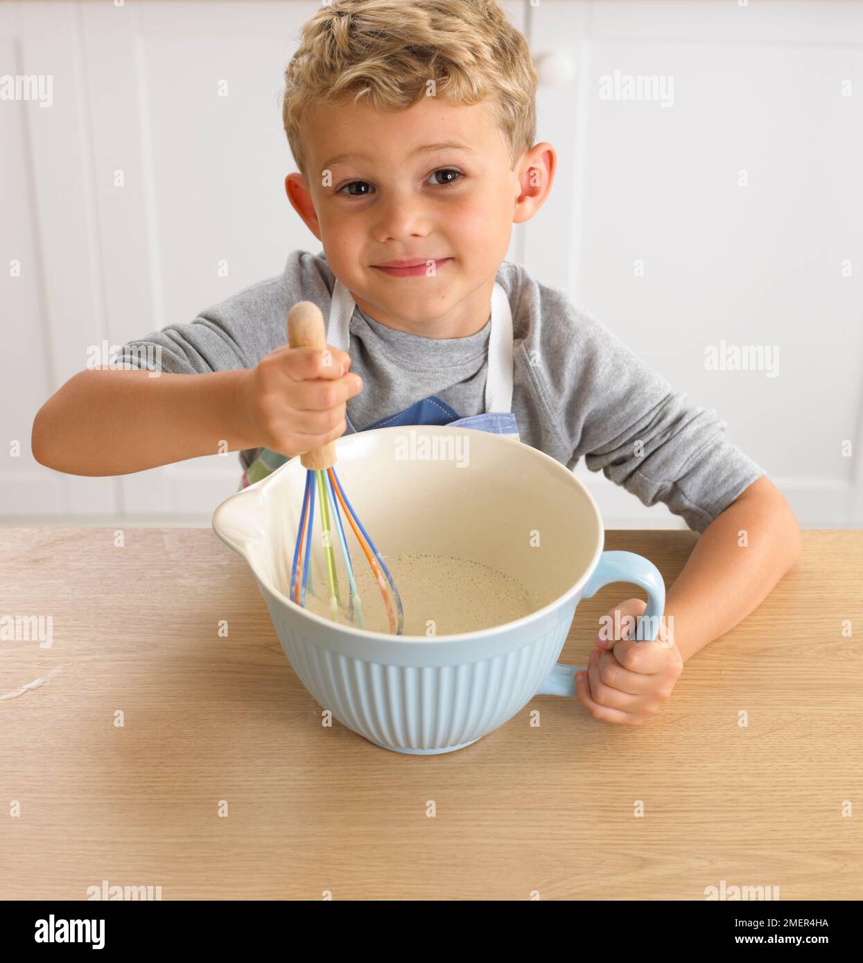 Boy whisking pancake mixture, 4 years Stock Photo - Alamy