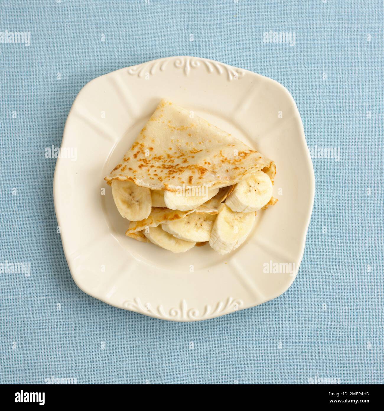 Folded pancake with banana Stock Photo - Alamy